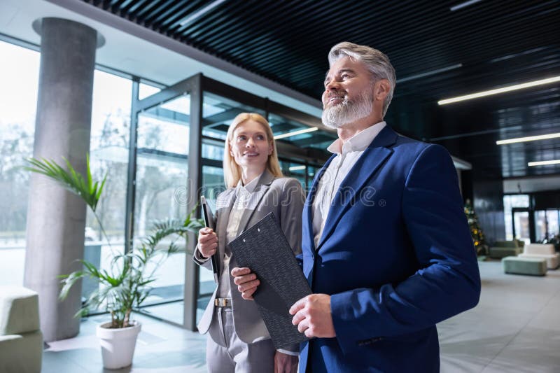 Male and Female Colleagues Talking in Office about Professional ...