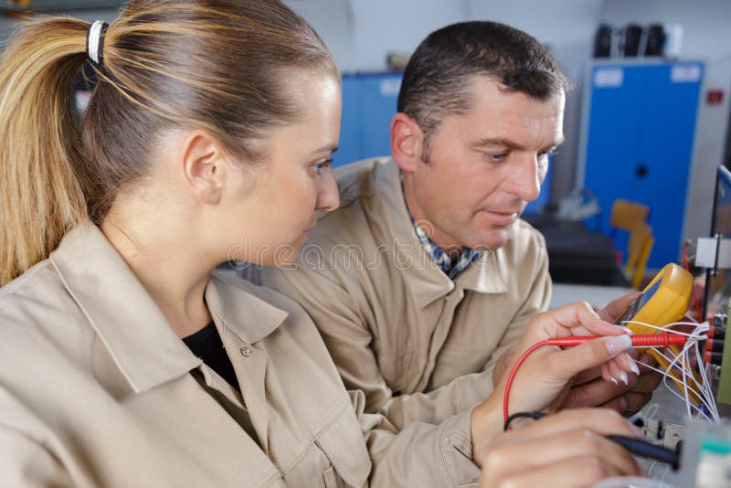 Male and Female Electricians Testing Circuit with Multimeter Stock ...