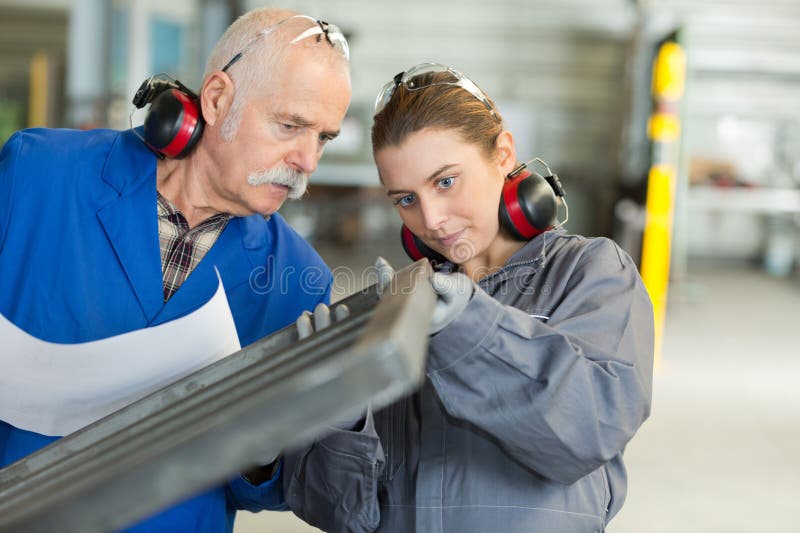 Male and Female Engineers Inspecting Metal Part Stock Image - Image of ...