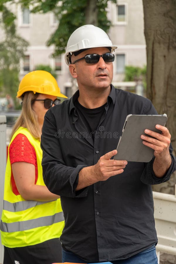 Male and Female Engineers at Work on Construction Site Editorial Stock ...