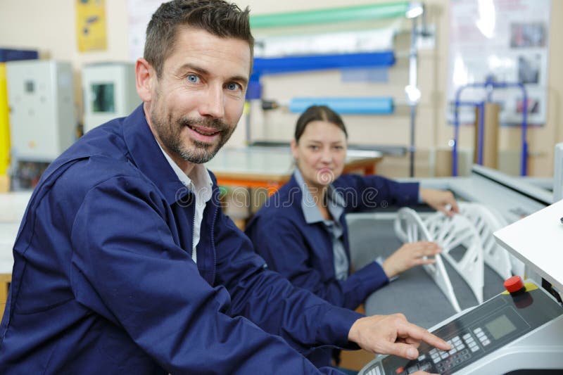 Male and Female Engineers Working in Manufacturing Workshop Stock Photo ...