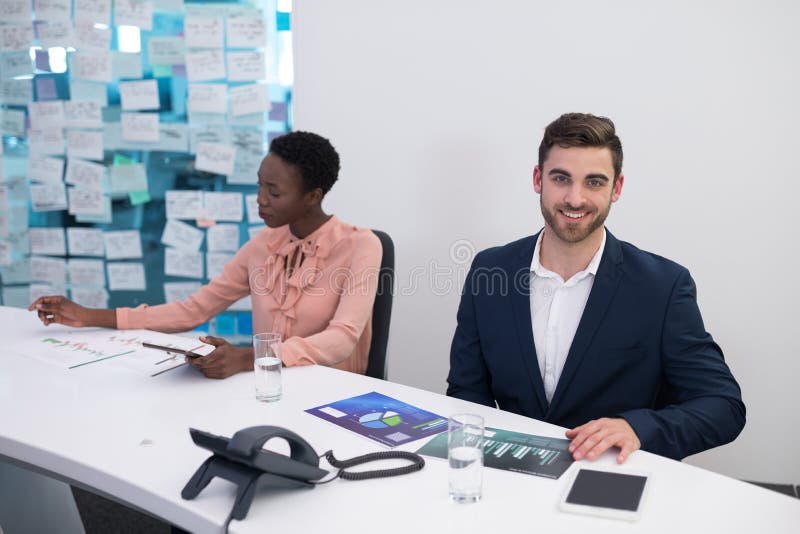 Male and Female Executives Looking at Graph Stock Photo - Image of ...