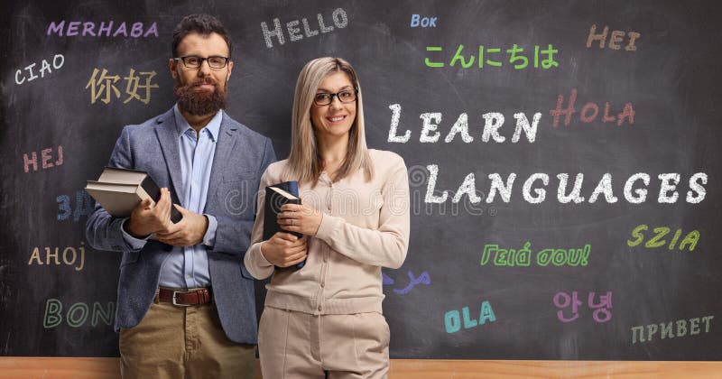 Male and Female Language Teachers in Front of a Blackboard Stock Photo ...