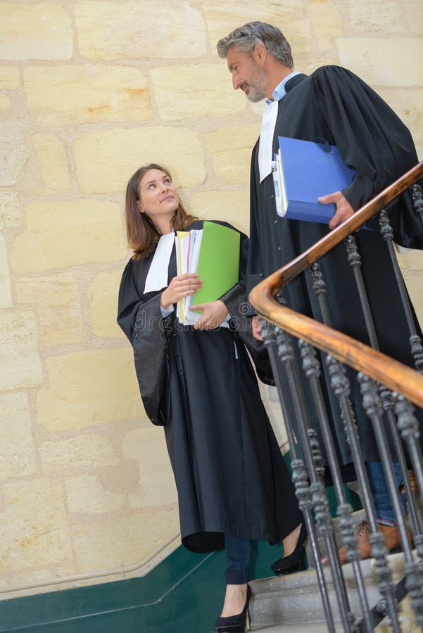 Female Magistrate Holding Up Hands To Male Counterpart Stock Photo ...