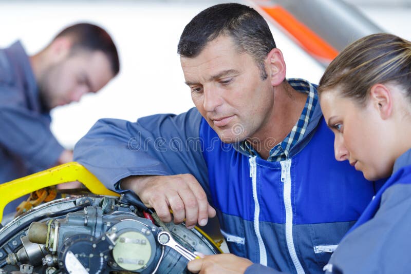 Male and Female Mechanic Team Examine Car Engine Stock Photo - Image of ...