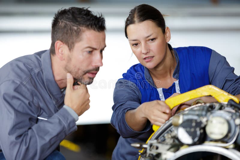 Male and Female Mechanics Working Together Stock Photo - Image of ...