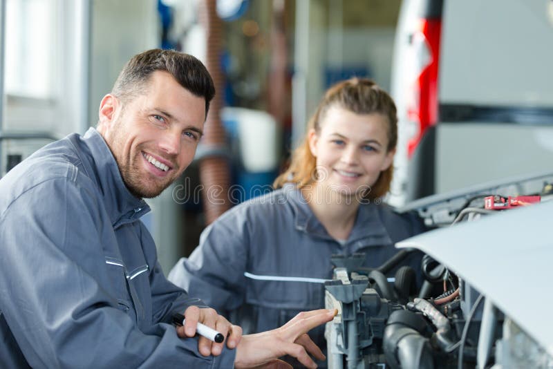Male and Female Mechanics Working Together Stock Image - Image of ...