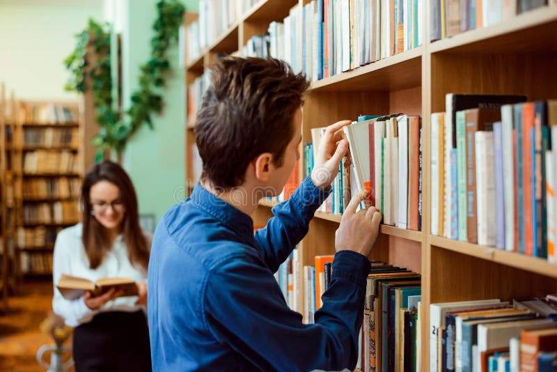 Male and Female Students in the Library Stock Image - Image of ...