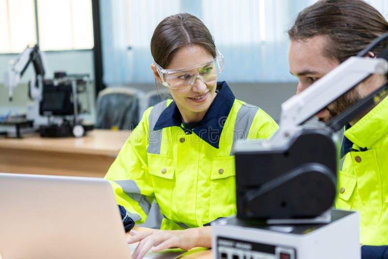 Male and Female Using Tablet Staff Engineer with Robot for Education at ...