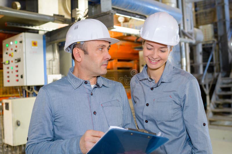 Discussion on Factory Floor Stock Photo - Image of inspector ...