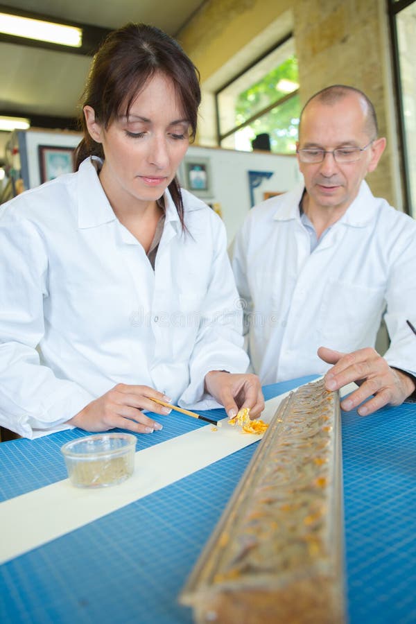 Male and Female Workers Making Picture Frame Stock Photo - Image of ...