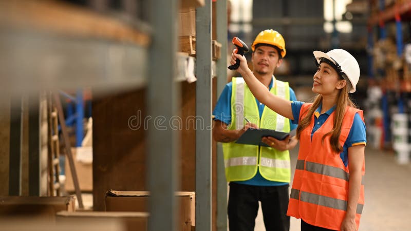 Two Young Warehouse Worker Using Barcode Scanner Checking Stock on the ...