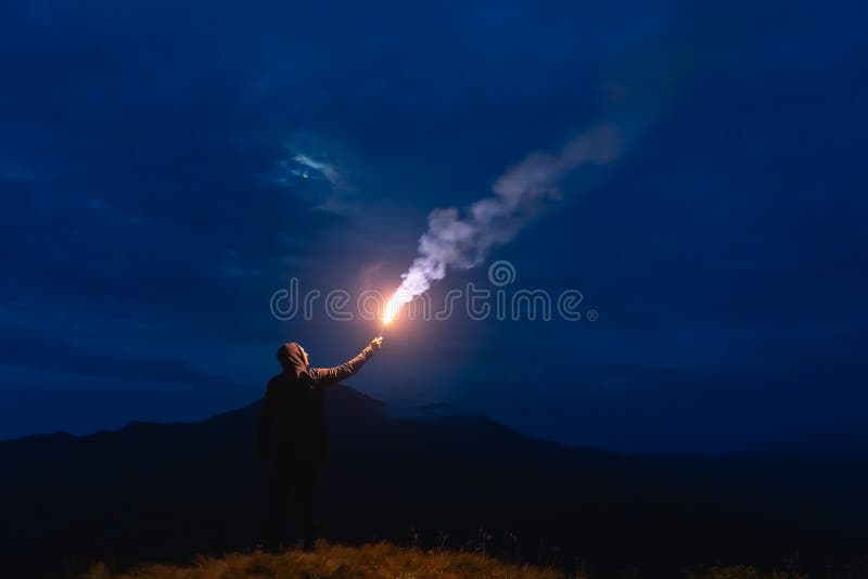 The Male with a Firework Stick Standing on a Mountain. Stock Image ...