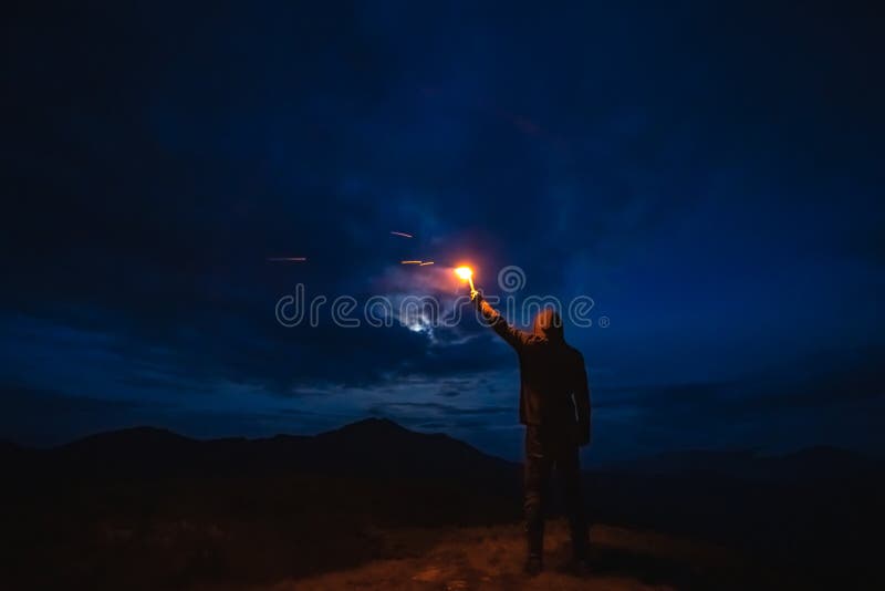 The Male with a Firework Stick Standing on a Mountain. Night Time ...
