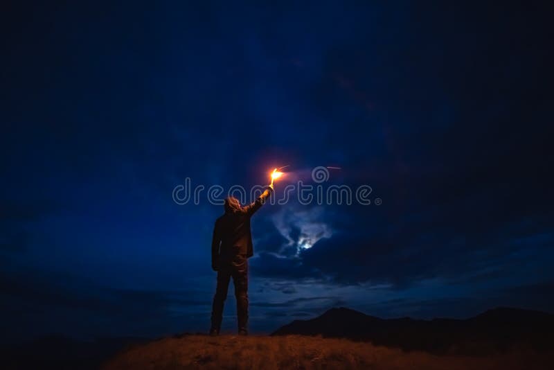The Male with a Firework Stick Standing on a Mountain. Evening Night ...