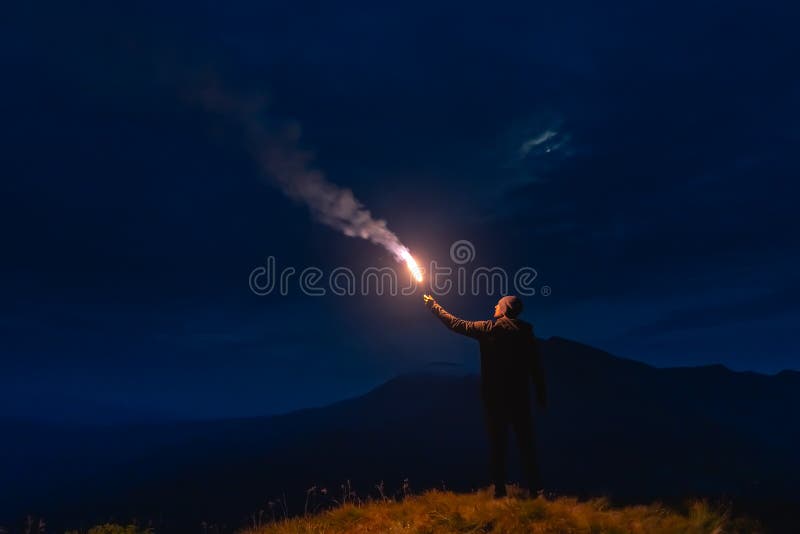 The Male with a Firework Stick Standing on a Mountain. Night Time ...