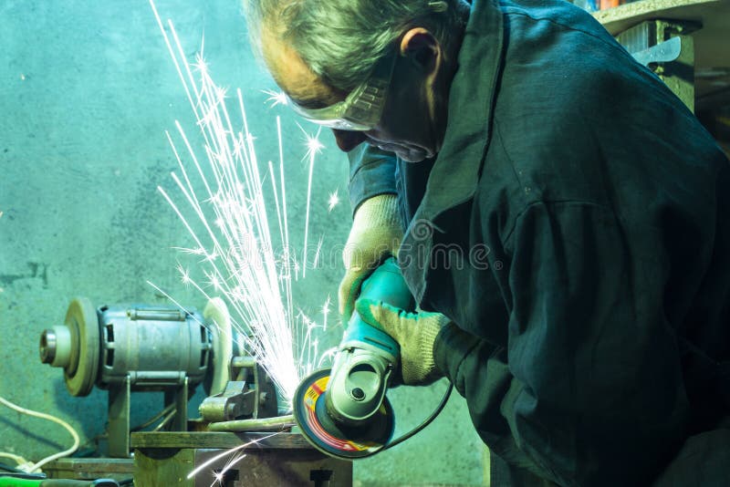 Male Fitter in Protective Gloves and Uniform Using Gringer Tool for ...