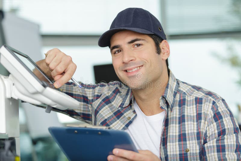 Male Fixing Printer Looking at Camera Stock Photo - Image of device ...