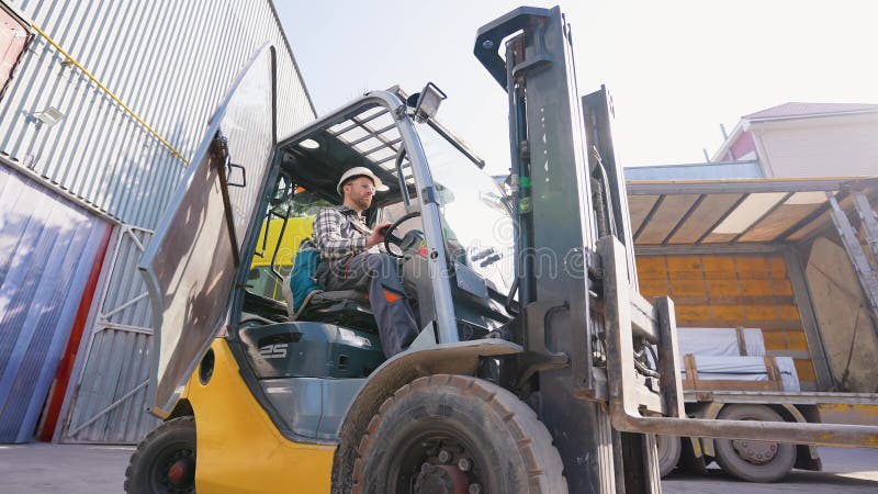 Male Forklift Driver Working on Loading and Unloading Goods in ...