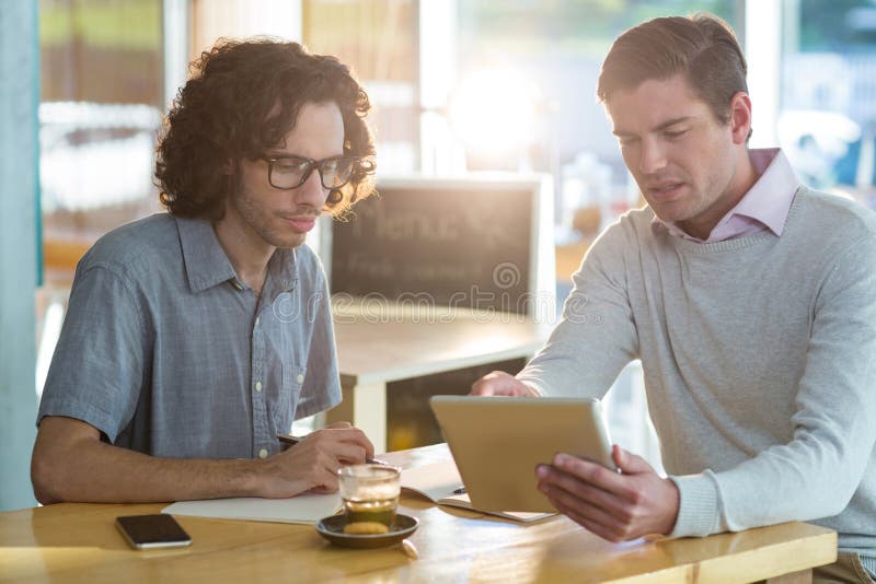 Male Friends Discussing on Digital Tablet Stock Image - Image of hotel ...