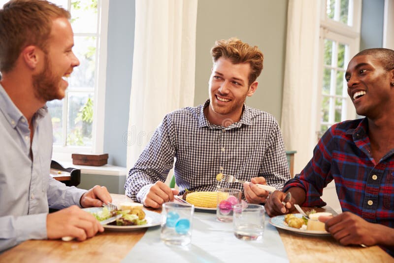 Male Friends at Home Sitting Around Table for Dinner Party Stock Image ...