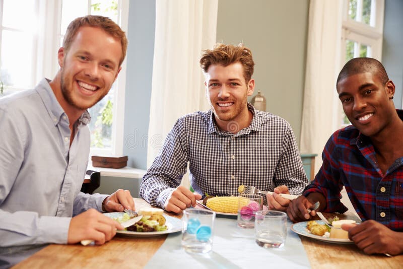 Male Friends at Home Sitting Around Table for Dinner Party Stock Image ...