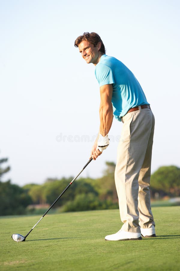 Male Golfer Teeing Off on Golf Course Stock Photo - Image of person ...