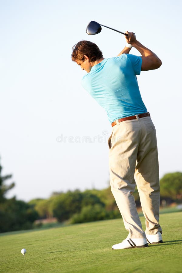 Male Golfer Teeing Off on Golf Course Stock Photo - Image of person ...