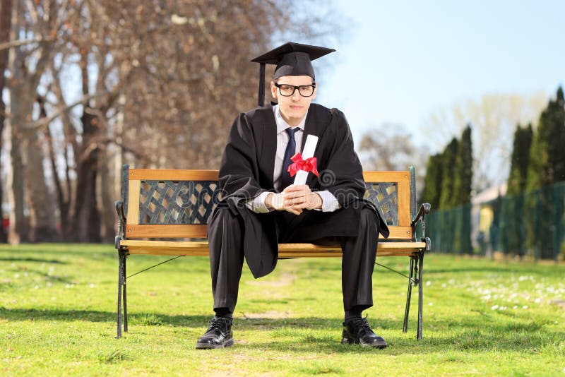Male Graduate Sitting on Bench and Holding Diploma Stock Photo - Image ...