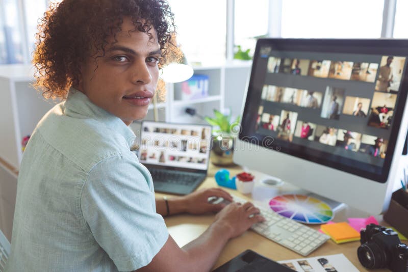 Male Graphic Designer Looking at Camera while Working Stock Image ...