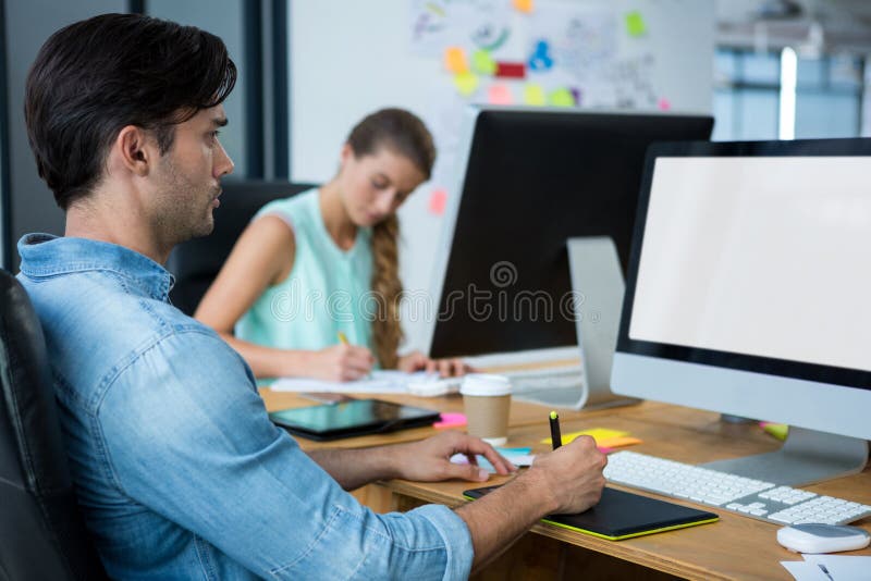 Male Graphic Designer Using Graphics Tablet at Desk Stock Image - Image ...