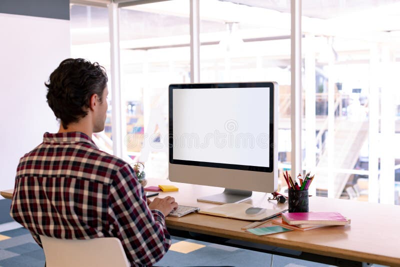 Male Graphic Designer Working on Computer at Desk in a Modern Office ...