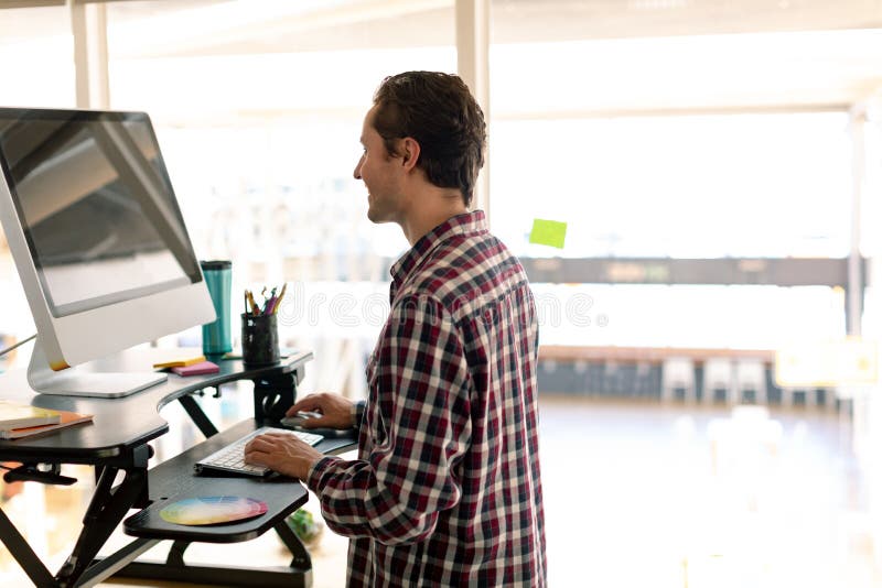 Male Graphic Designer Working on Computer at Desk Stock Image - Image ...