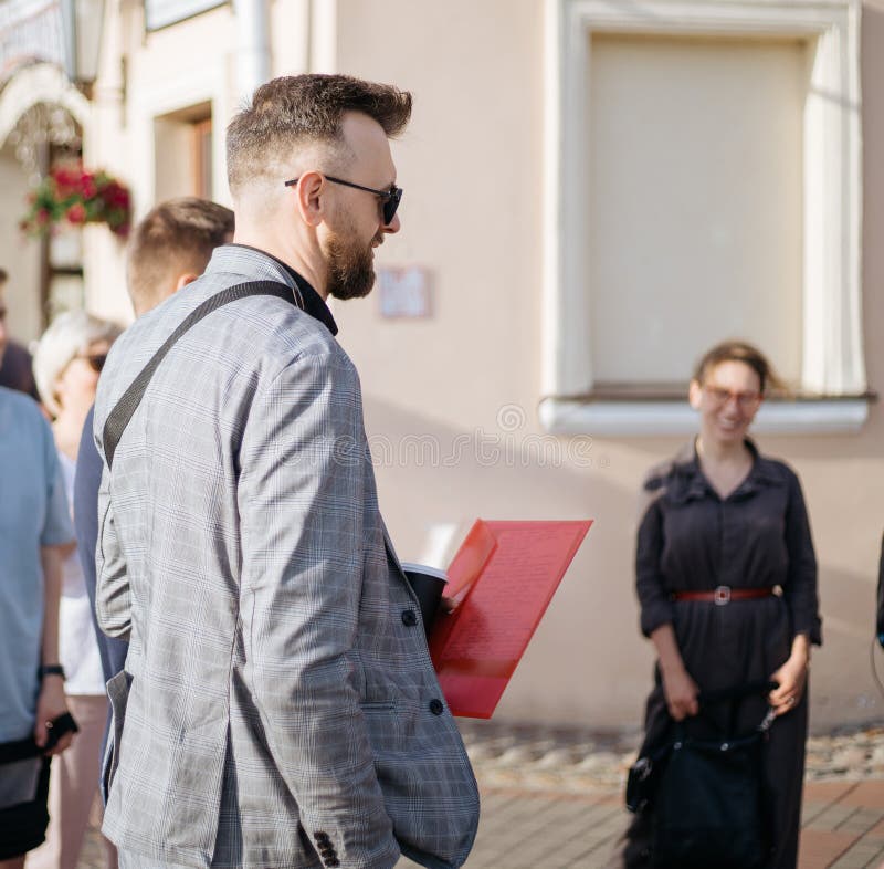 Male Guide Standing among a Group of Tourists. Stock Photo - Image of ...