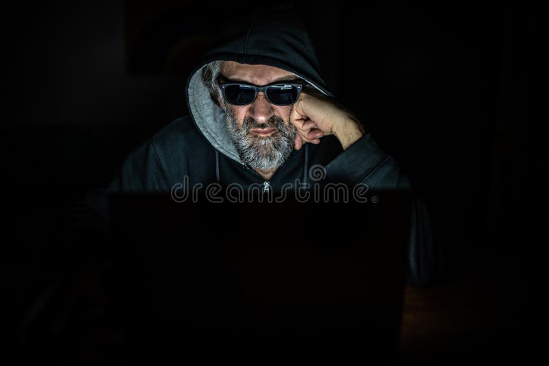 Male Hacker with Beard and Sunglasses Working on His Laptop, Victorious ...