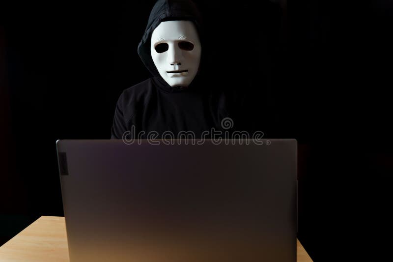 Male Hacker Dressed in Black with a Hood and a White Mask Stock Image ...