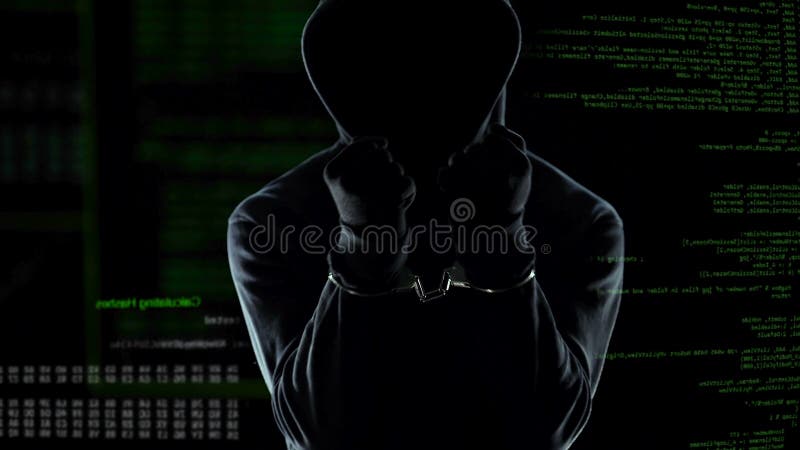 Male Hacker with Handcuffs Standing in Front of Animated Computer Code ...