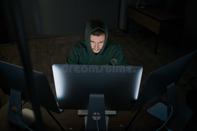 Male Hacker in Hood Works on Computer, Front View Stock Image - Image ...