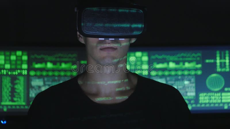 Male Hacker Programmer Uses a Virtual Reality Helmet for Programming ...