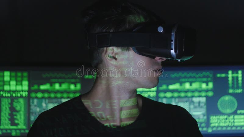 Male Hacker Programmer Uses a Virtual Reality Helmet for Programming ...