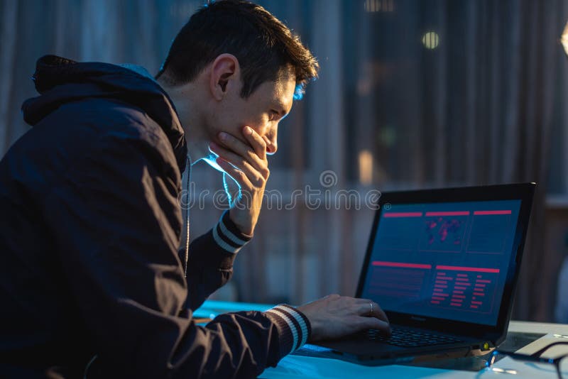 Male Hacker Thinking About The Problem Of Hacking And Stealing Access Databases With Passwords