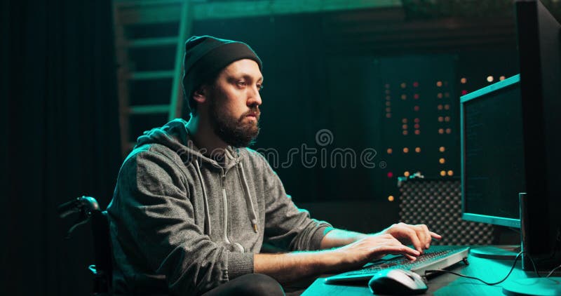 Male Hacker Using Keyboard To Type a Dangerous Malware into Bank System ...