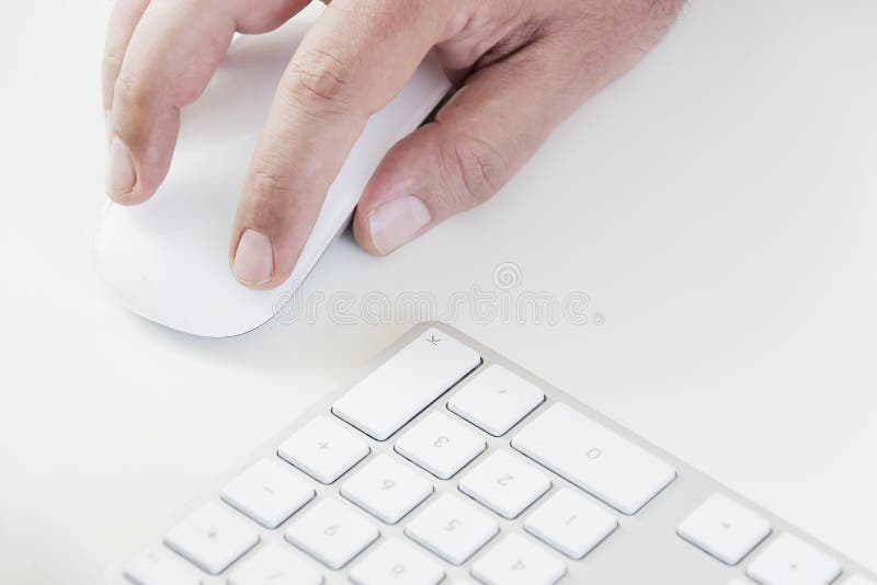 Male Hand Clicking on a White Mouse with a White Keyboard on the Right ...