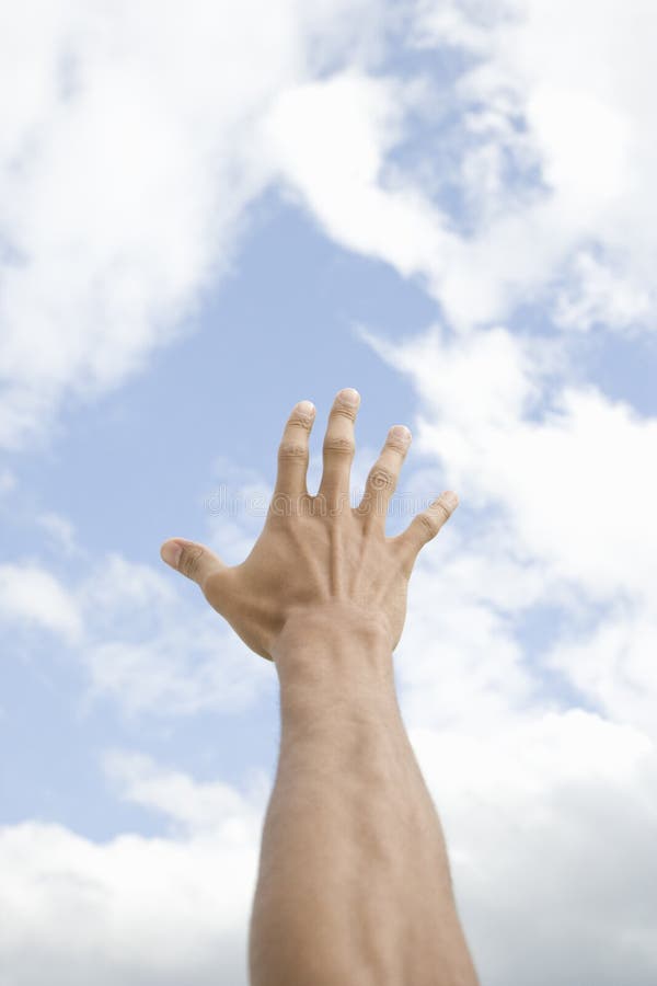 Male Hand Extended Toward Sky Stock Image - Image of clouds, blue: 12564587