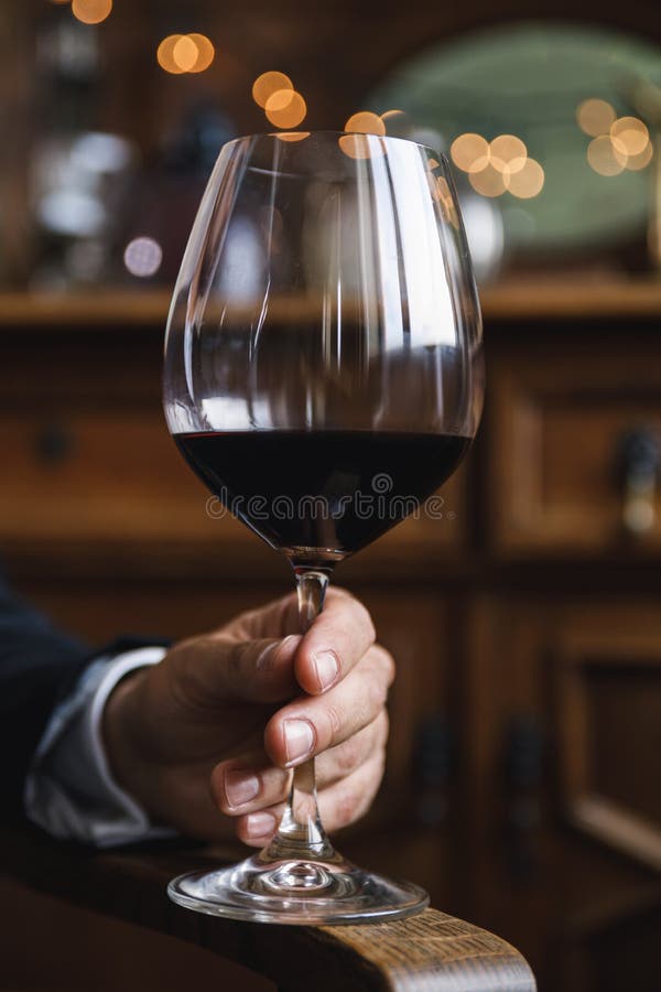Male Hand with a Glass of Red Wine Stock Image - Image of garland ...