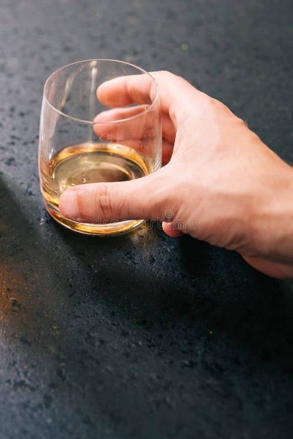 Male Hand Grasping a Glass with Whisky Stock Photo - Image of table ...