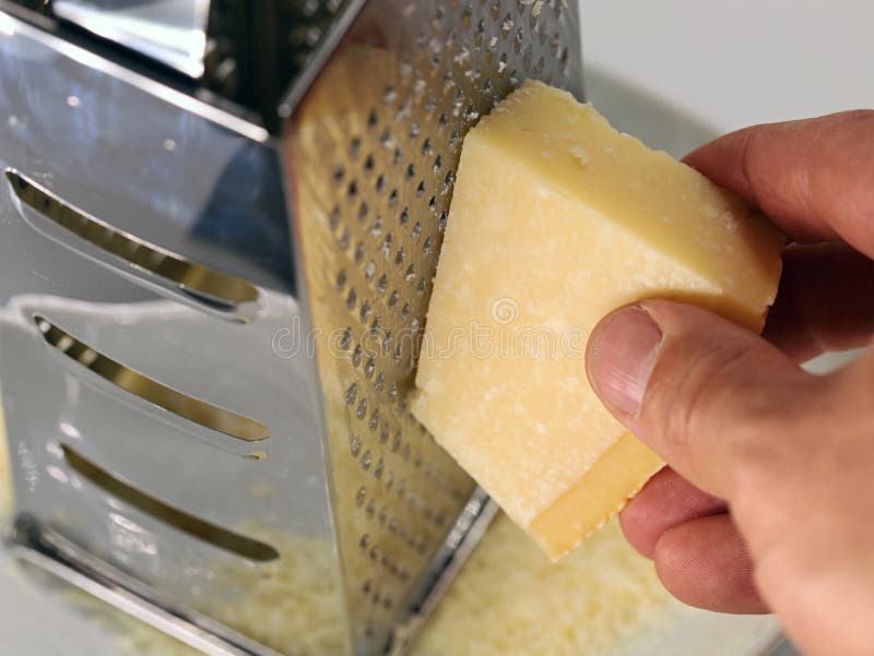 Male Hand Grating Parmesan Cheese on a Metall Kitchen Grater, Closeup ...