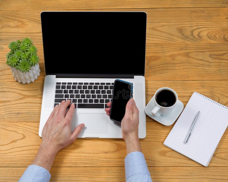 Male Hand Holding Cell Phone while Using Laptop Computer Stock Photo ...
