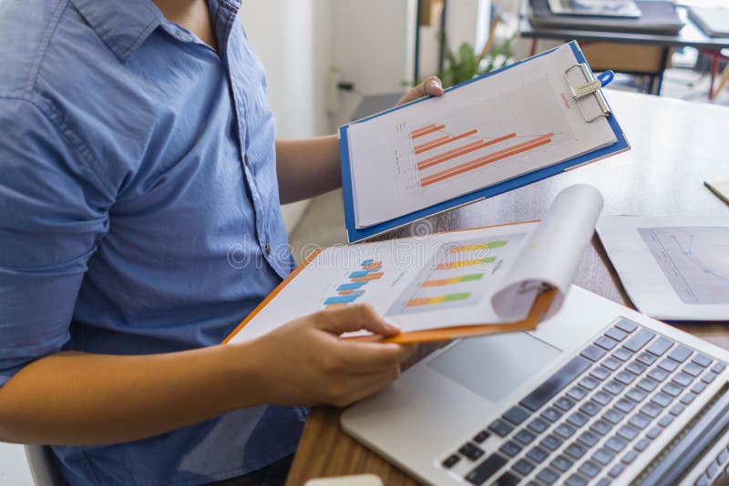Male Hand Holding Financial Reports and Reading Stock Image - Image of ...