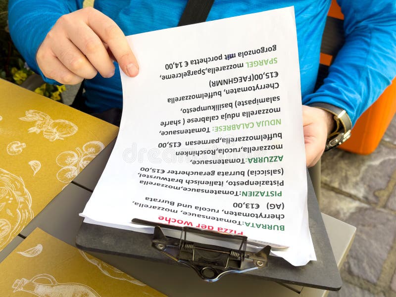 Male Hand Holding Italian Pizza Menu with Colored Text Outdoors ...